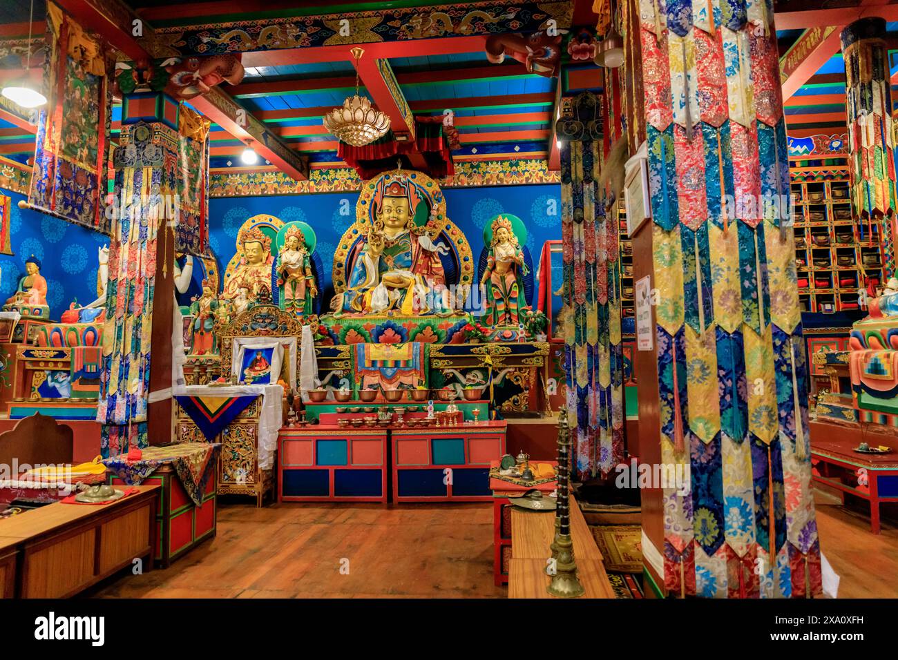 Buddhist temple interior featuring ornate decorations, statues of ...