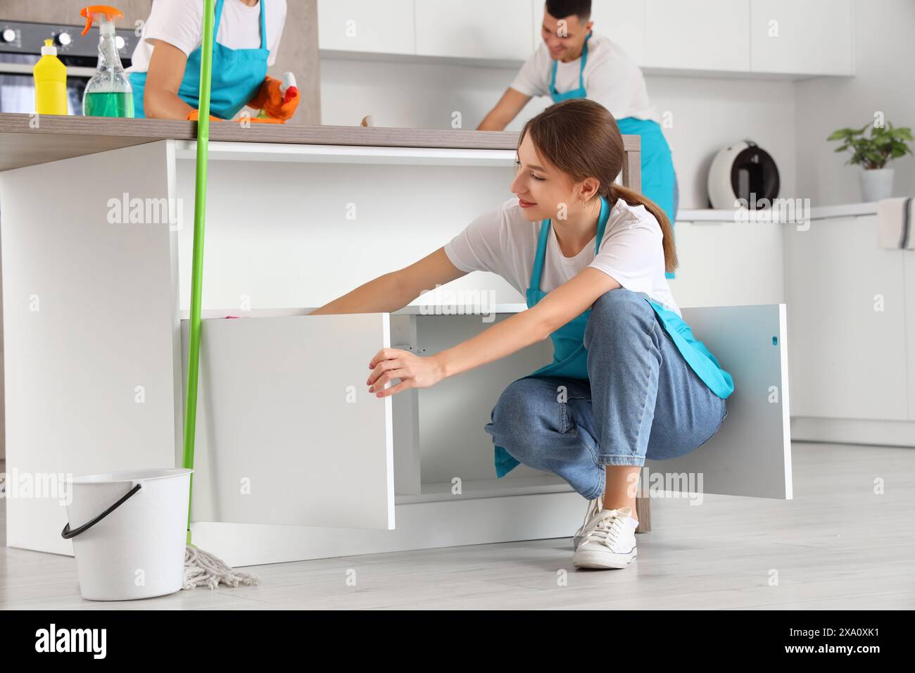 Female janitor cleaning drawer in kitchen Stock Photo - Alamy