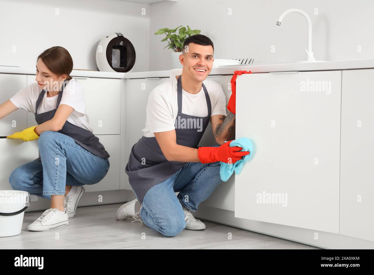 Male janitor cleaning drawer in kitchen Stock Photo - Alamy