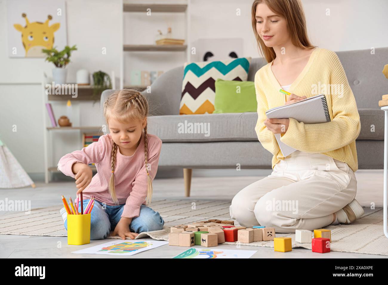 Little girl with psychologist drawing in office Stock Photo - Alamy