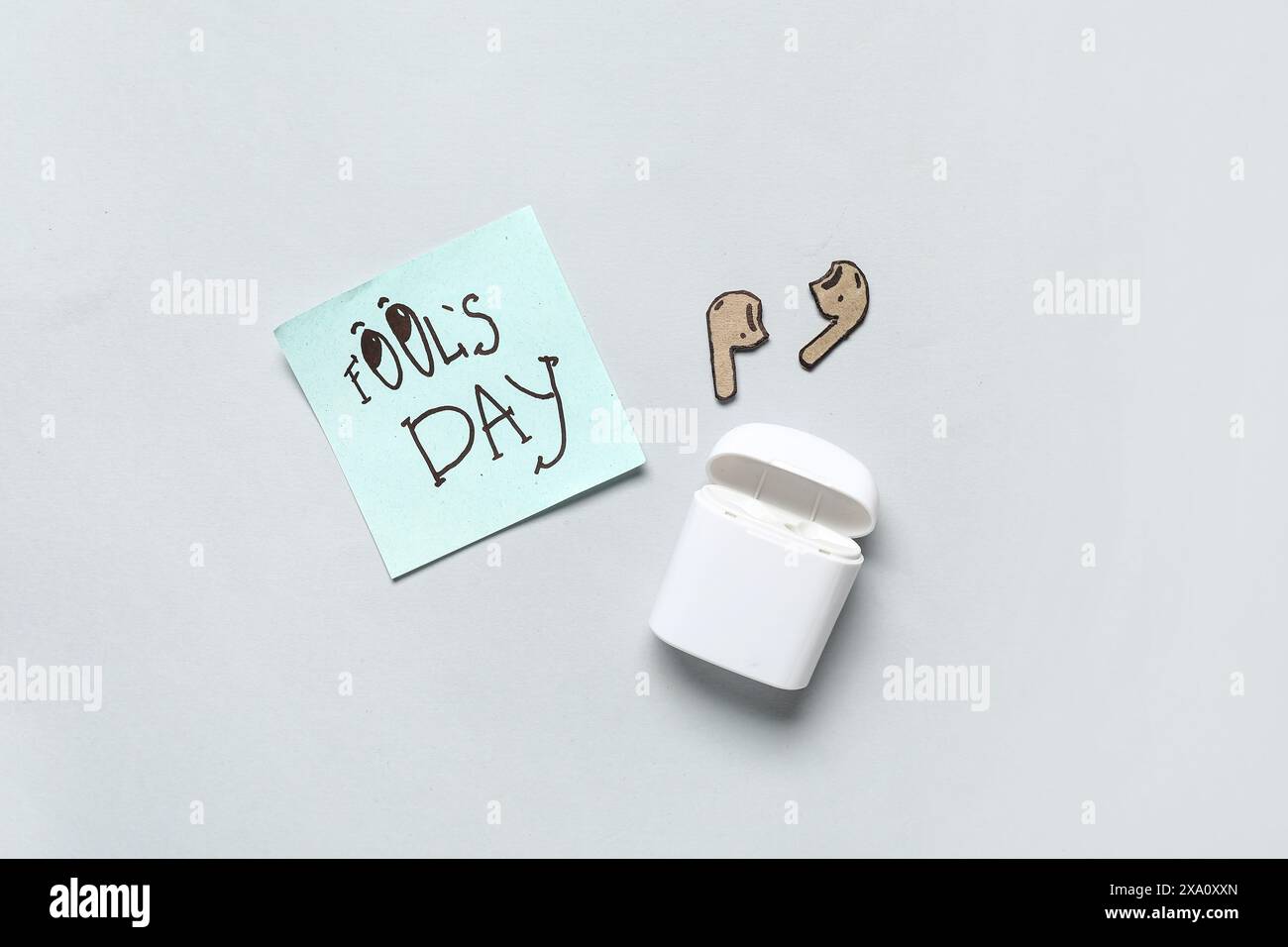 Carton earphones and sticky note on white background. April Fools Day ...