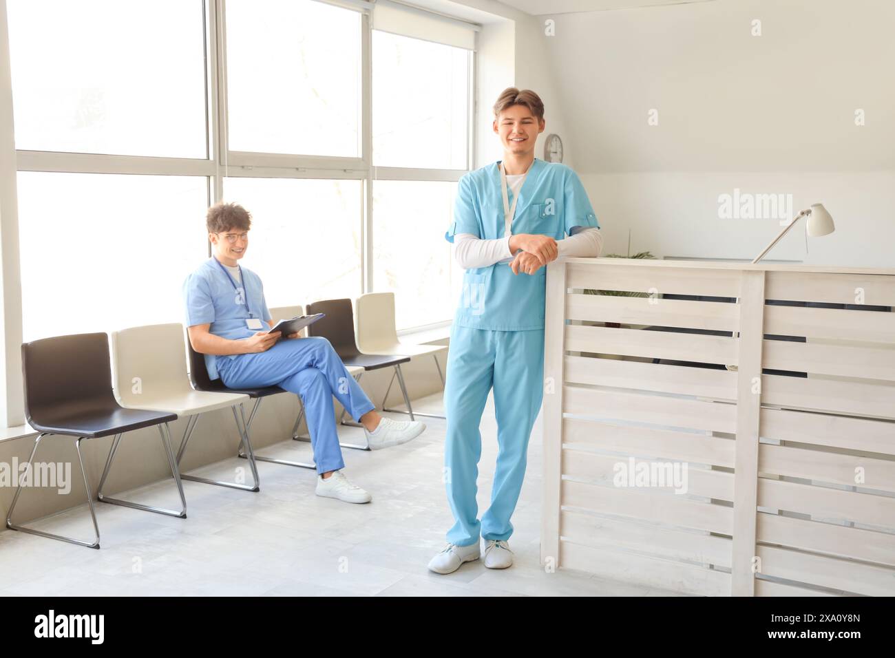 Male medical interns in clinic hall Stock Photo - Alamy