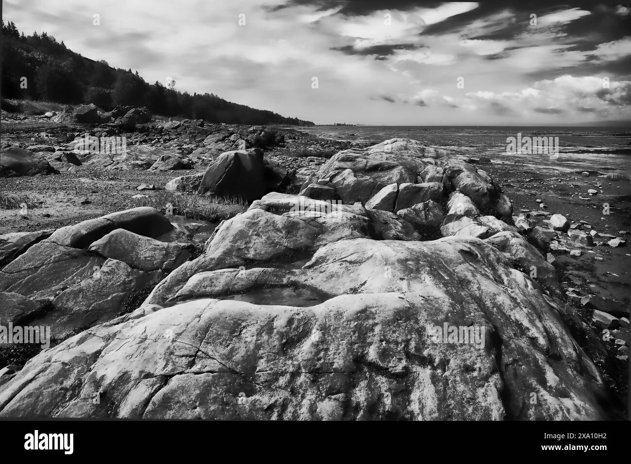 Beach rocks water in background Black and White Stock Photos & Images ...