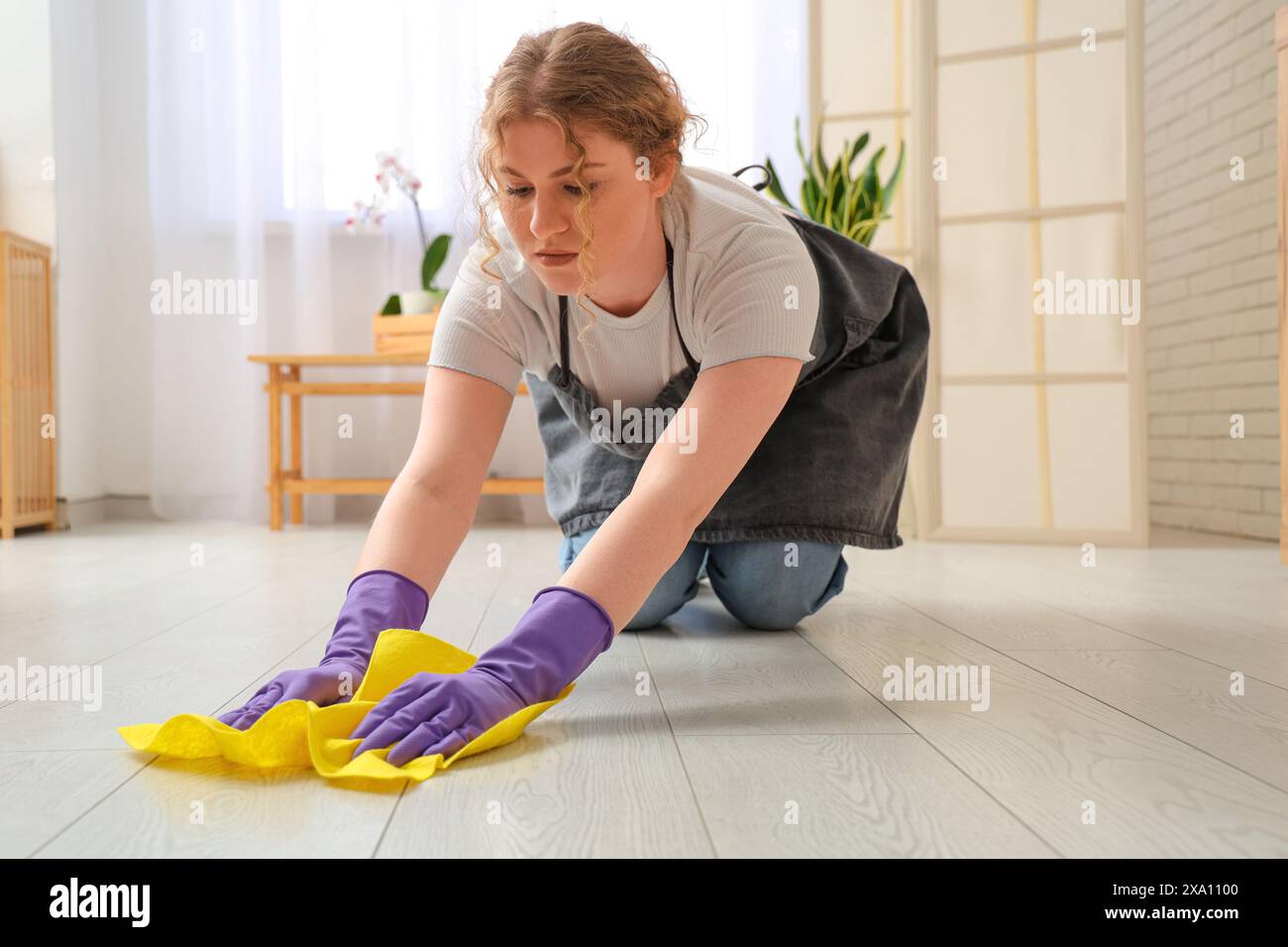 Female janitor cleaning floor in room Stock Photo - Alamy