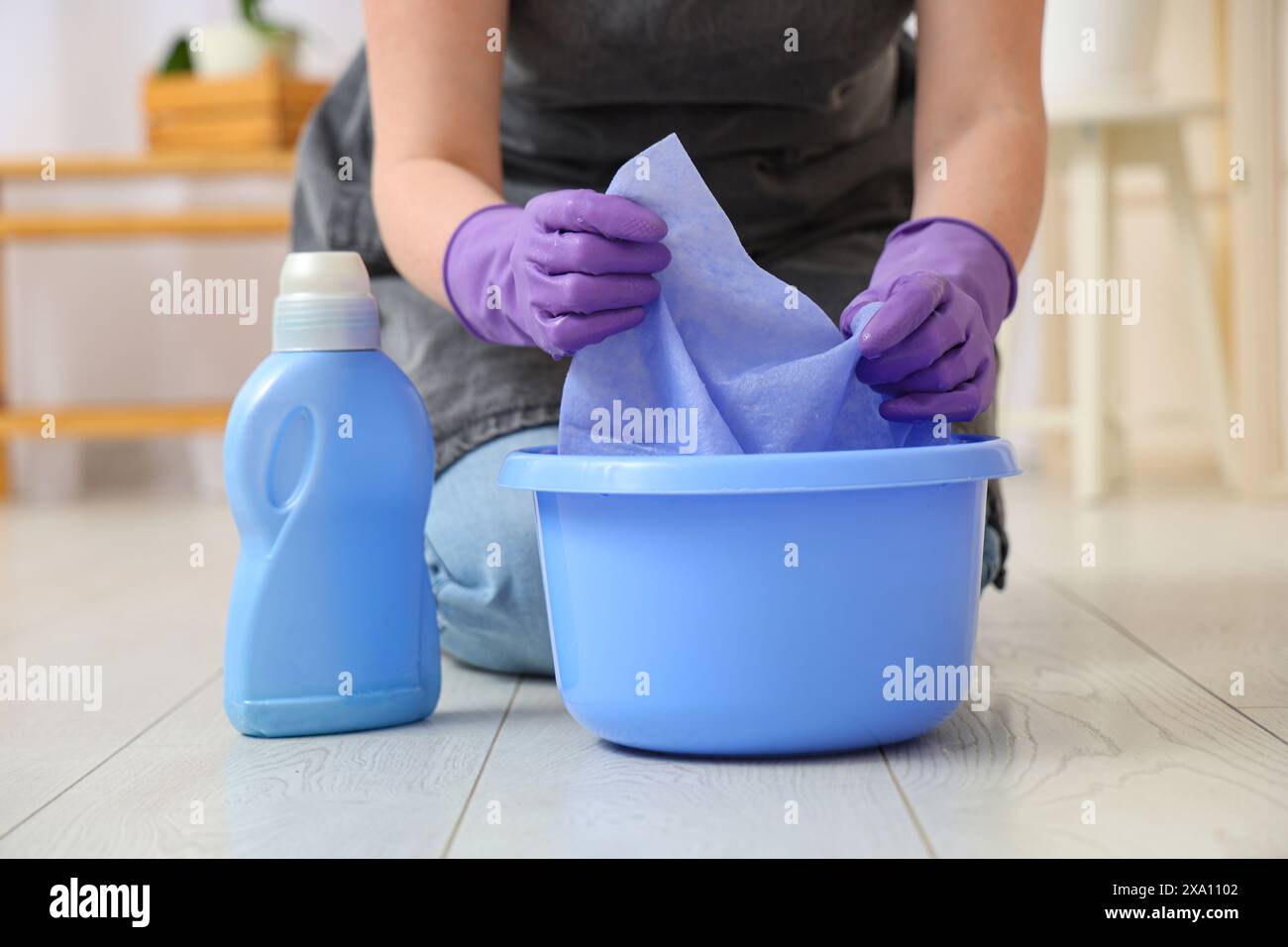 Female janitor soaking rag in water, closeup Stock Photo - Alamy