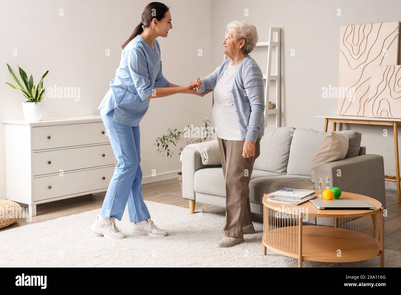 Physiotherapist helping patient walk hi-res stock photography and ...