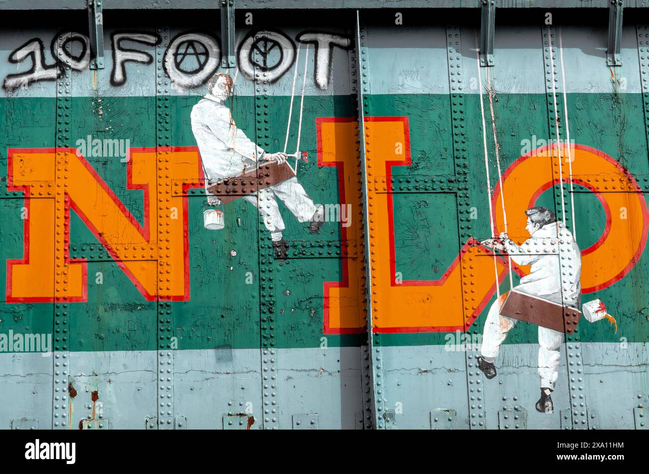 The bridge graffiti art of two men on a swing painting the wall Stock ...
