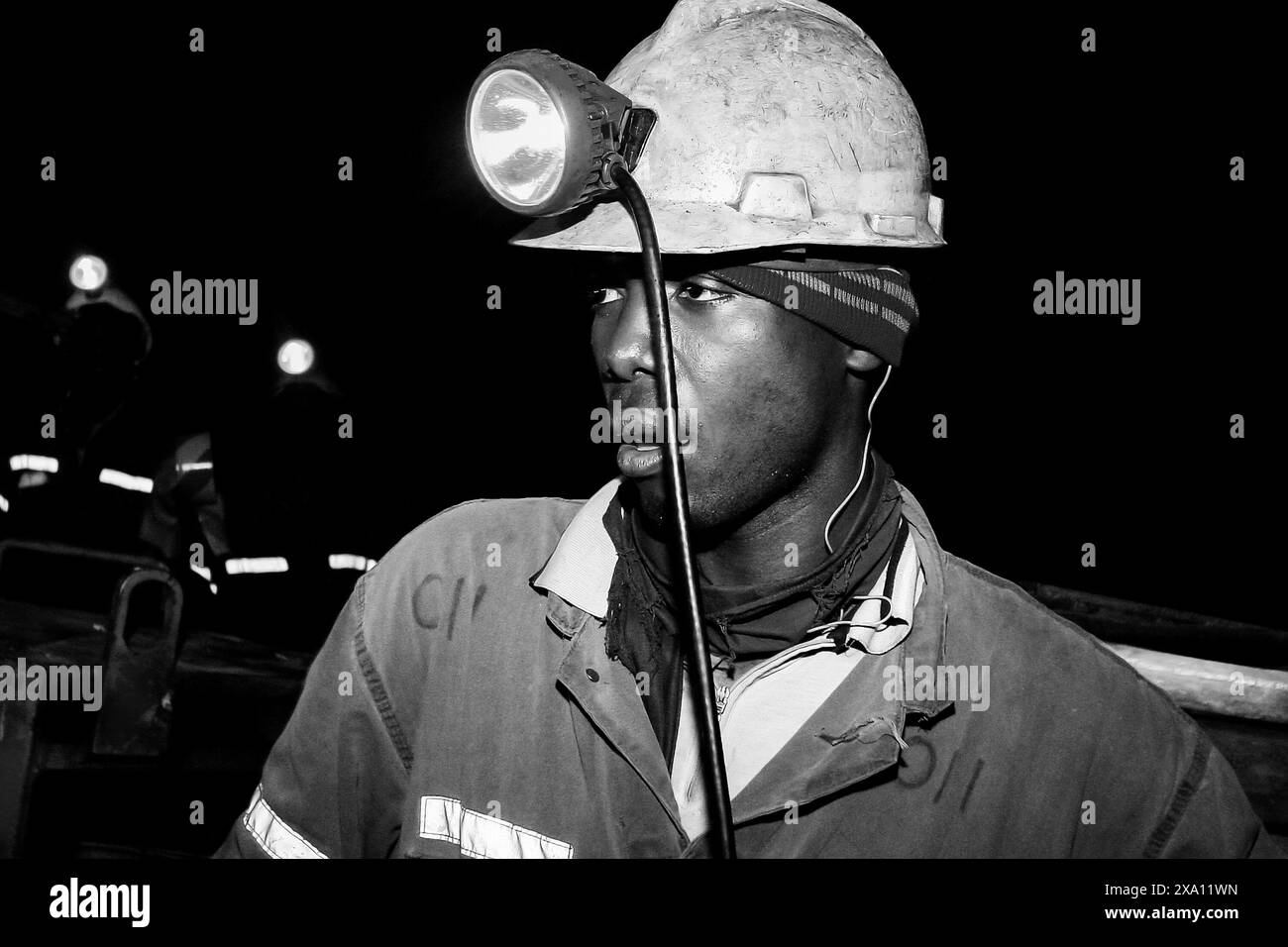 An African firefighter in a protective helmet in grayscale Stock Photo ...