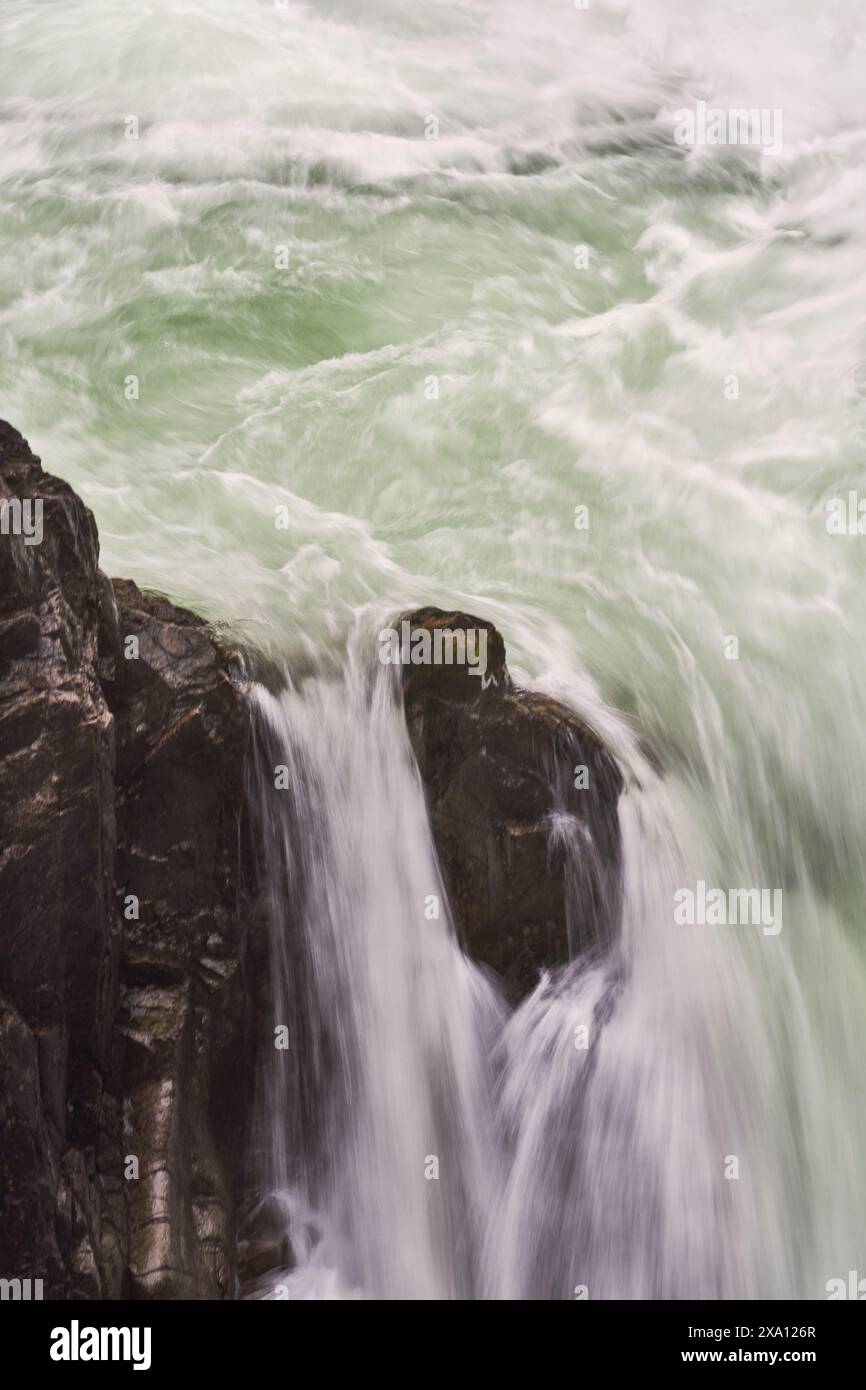 The water cascading over a cliff at Little Qualicum Falls Stock Photo ...