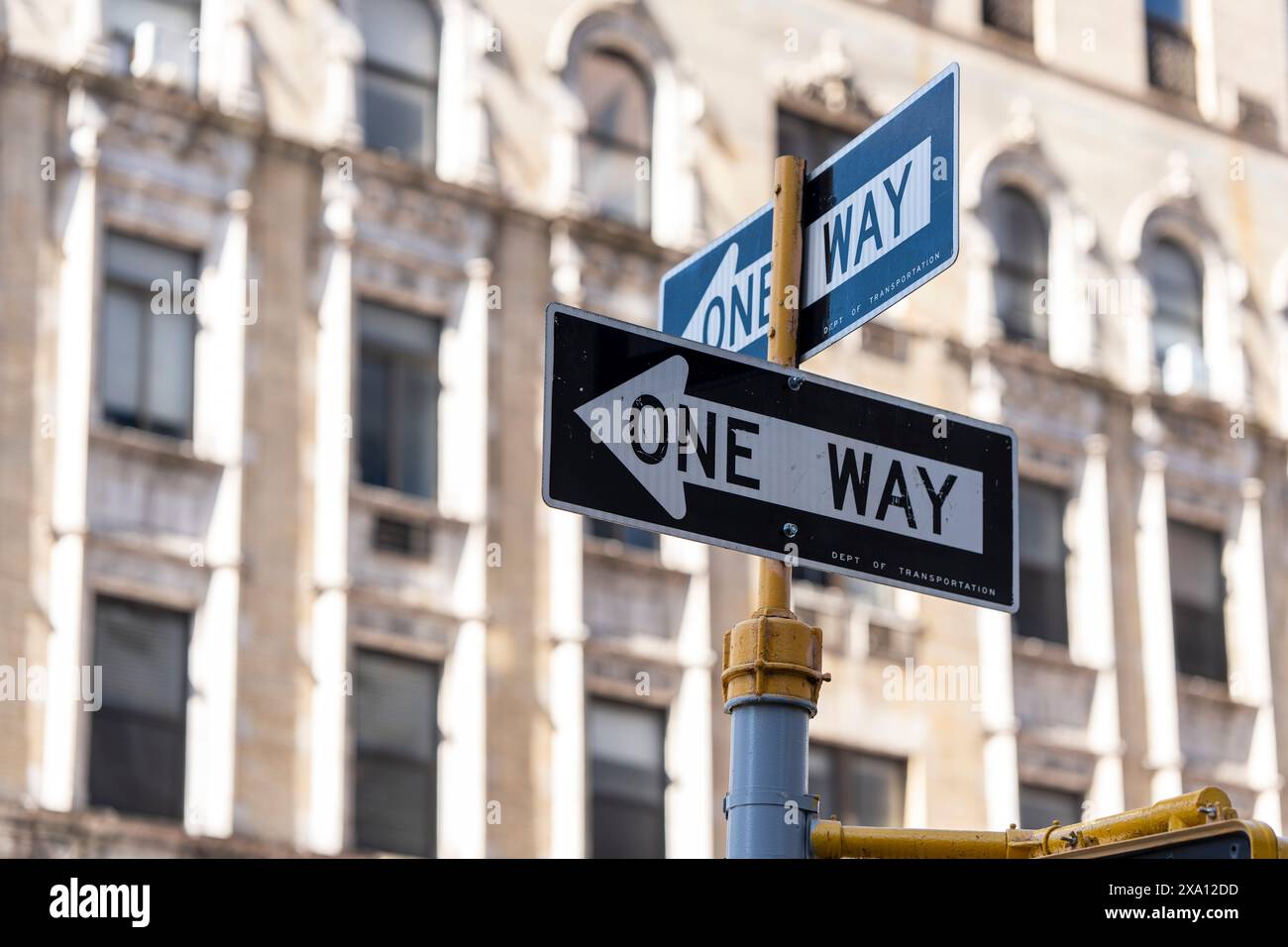 The One way signs with a city backdrop Stock Photo - Alamy