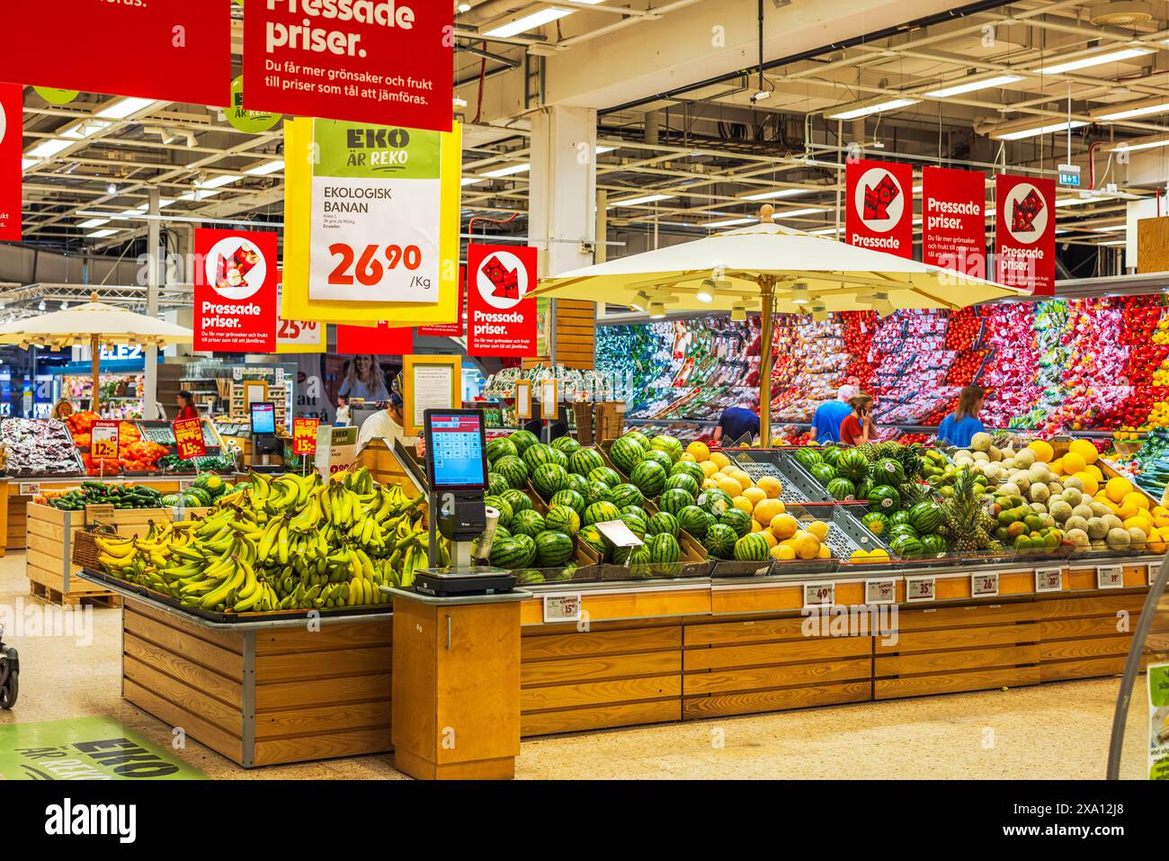 A wide view of a colorful produce section in a grocery store with ...