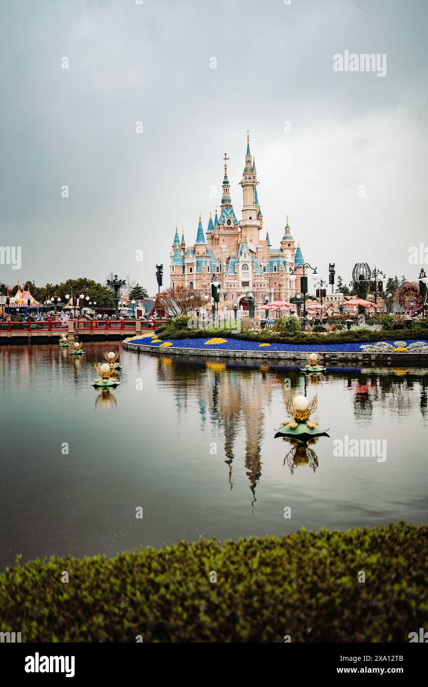 The Disney castle on a cloudy day, along with its reflection in the ...