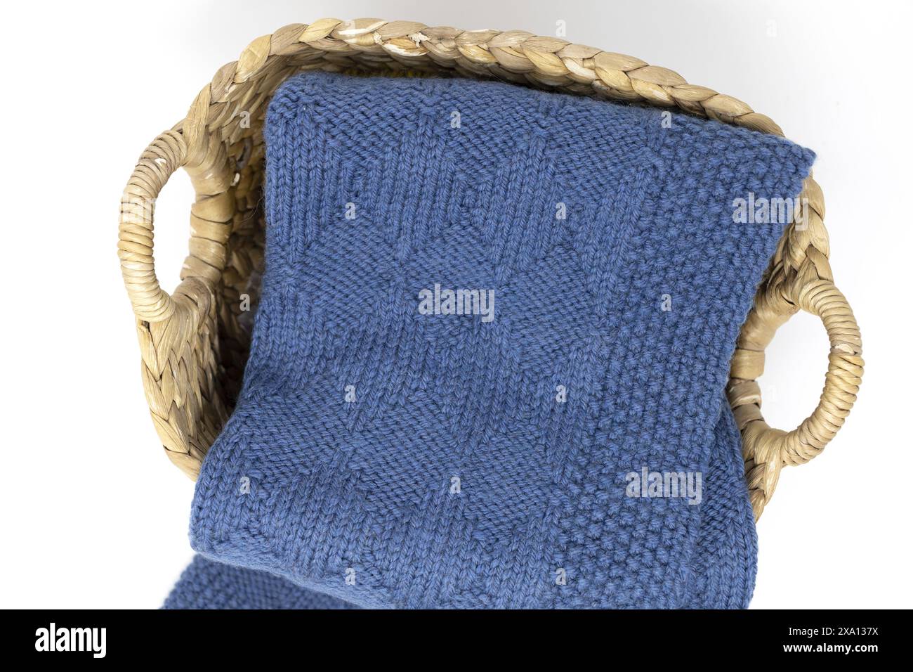 Tabletop photography of a blue knitted blanket in harlequin knitting ...