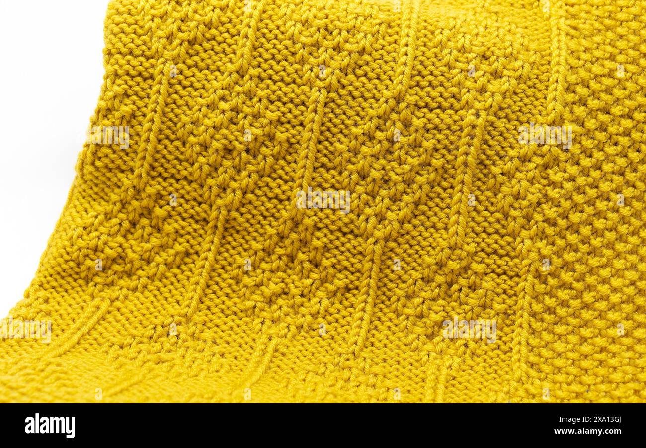 Close-up photography of a yellow wool knitted blanket texture, details ...
