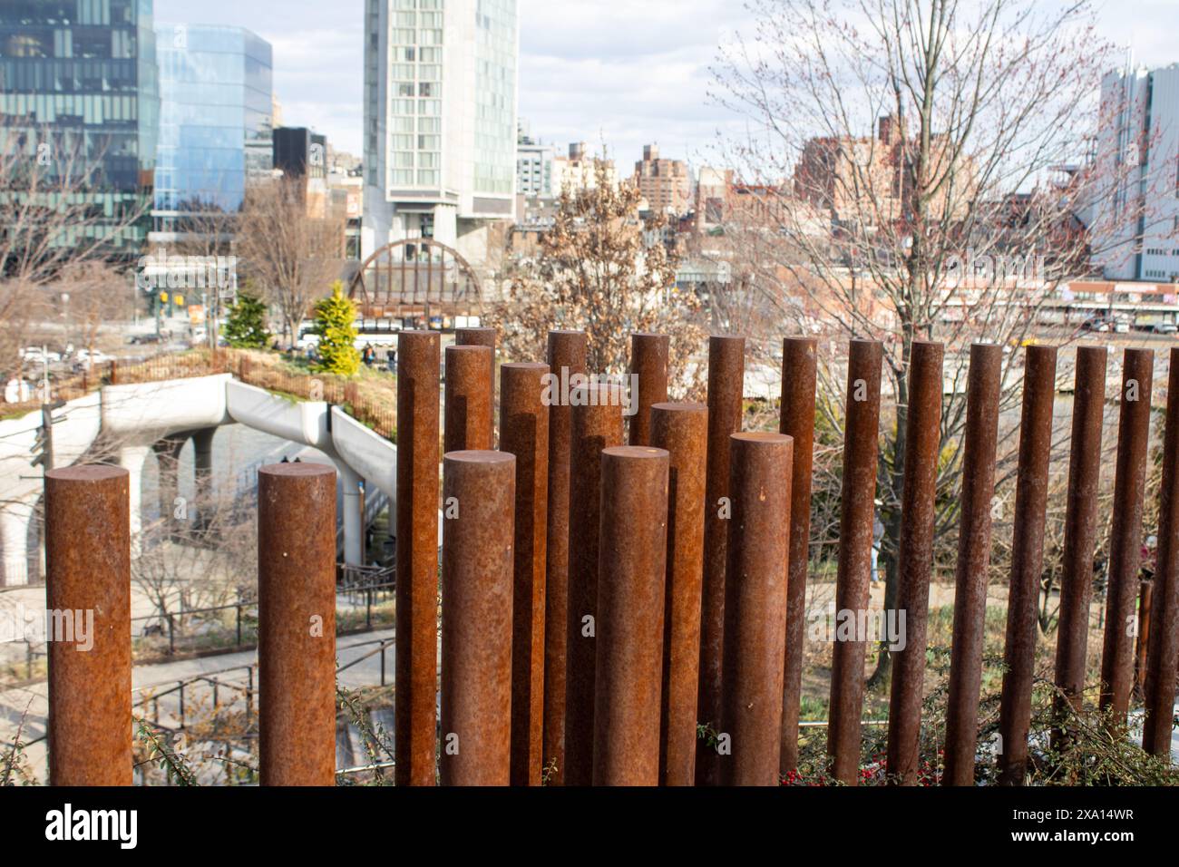 A rusted fence with buildings in background Stock Photo - Alamy
