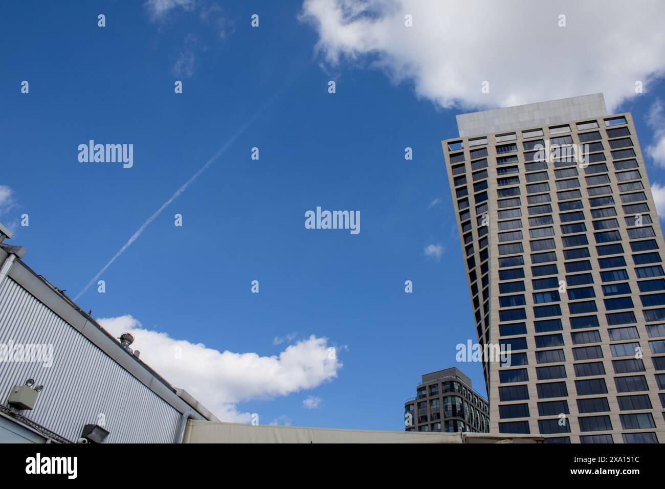 A high-rise skyscraper towering over surrounding buildings in a ...