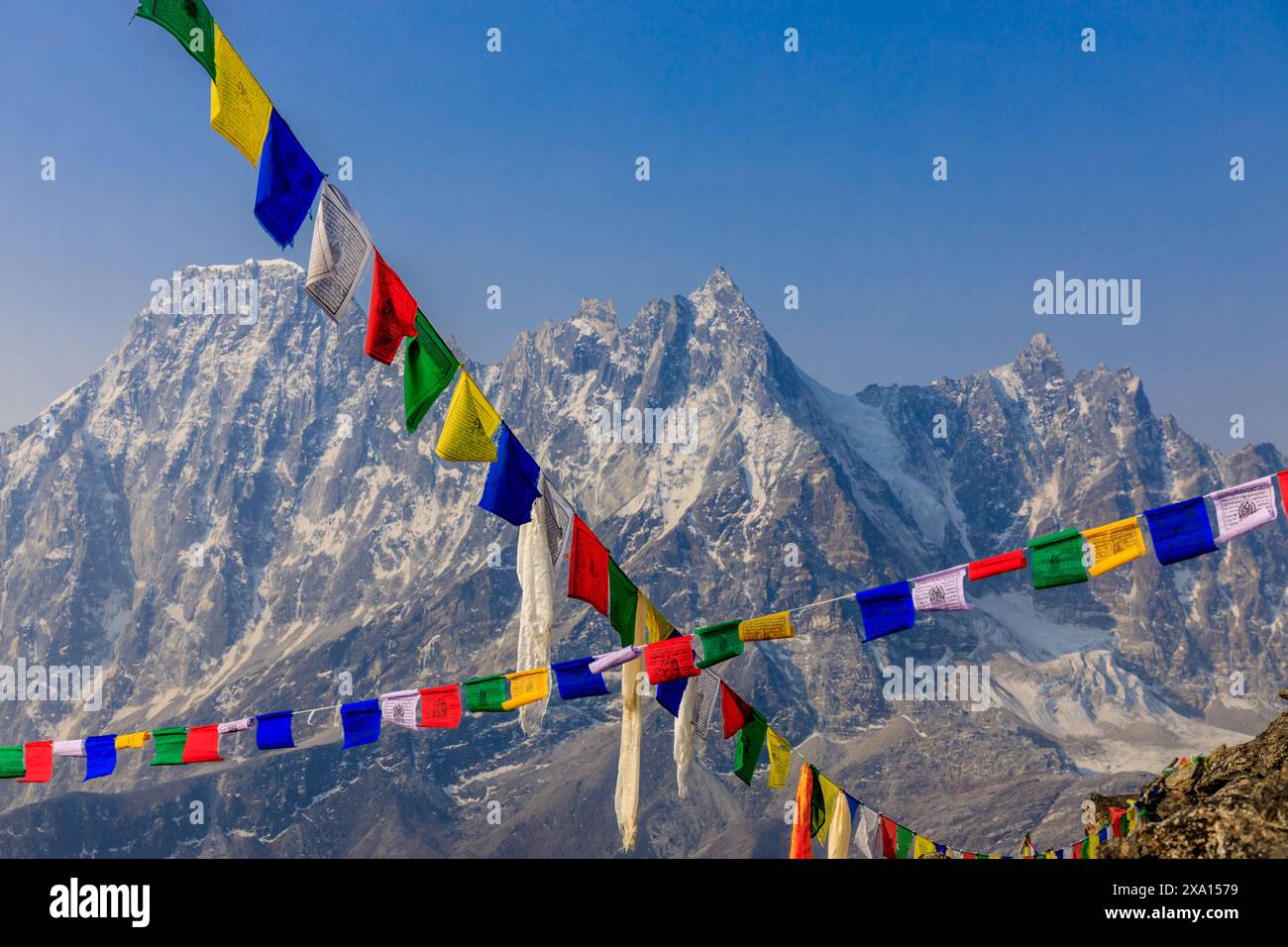 Colorful Nepali and Tibetan prayer flags fluttering in the majestic ...