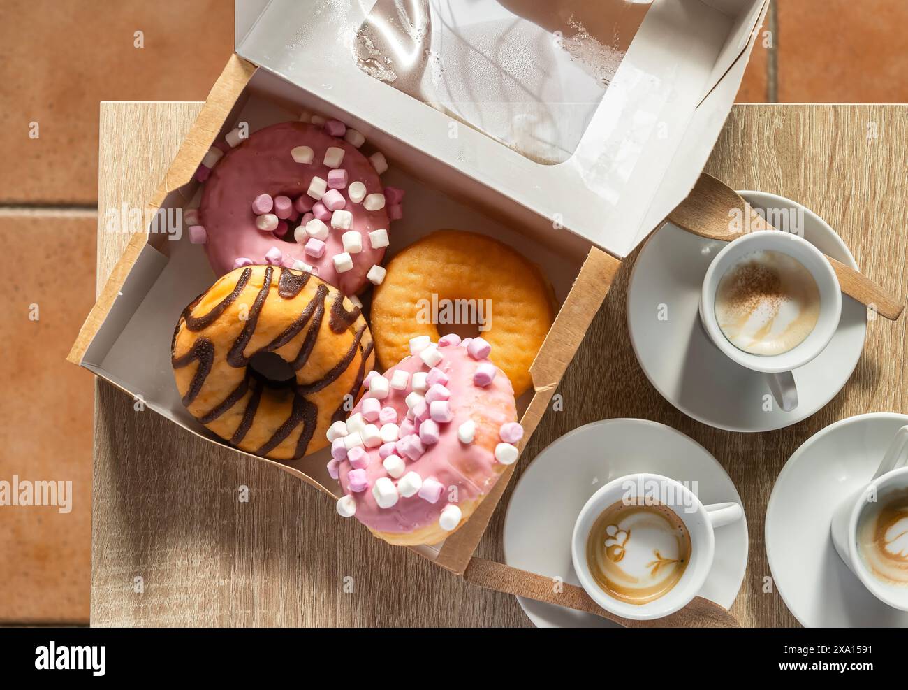 Top view of a breakfast or snack with donuts and coffee, doughnuts day Stock Photo - Alamy