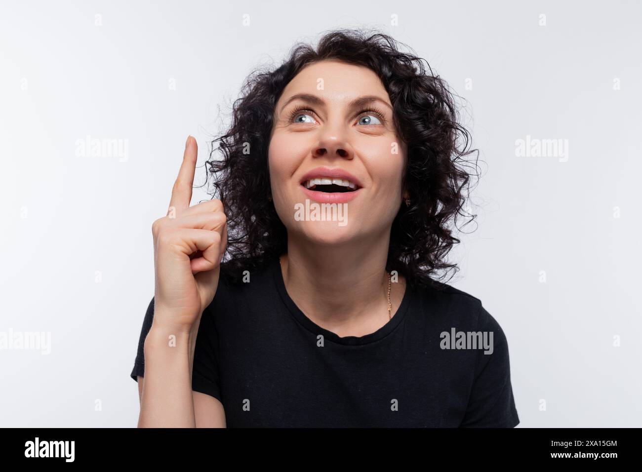 Portrait of a smart woman with a bio-perm dressed in a basic t-shirt ...