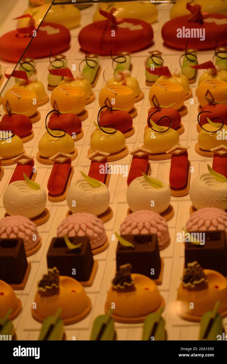 A close-up of various sweets and pastries displayed on shelves in a ...