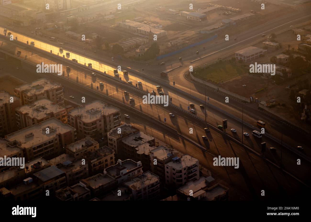 An aerial view of vehicles driving on a highway at sunset. Cairo, Egypt ...