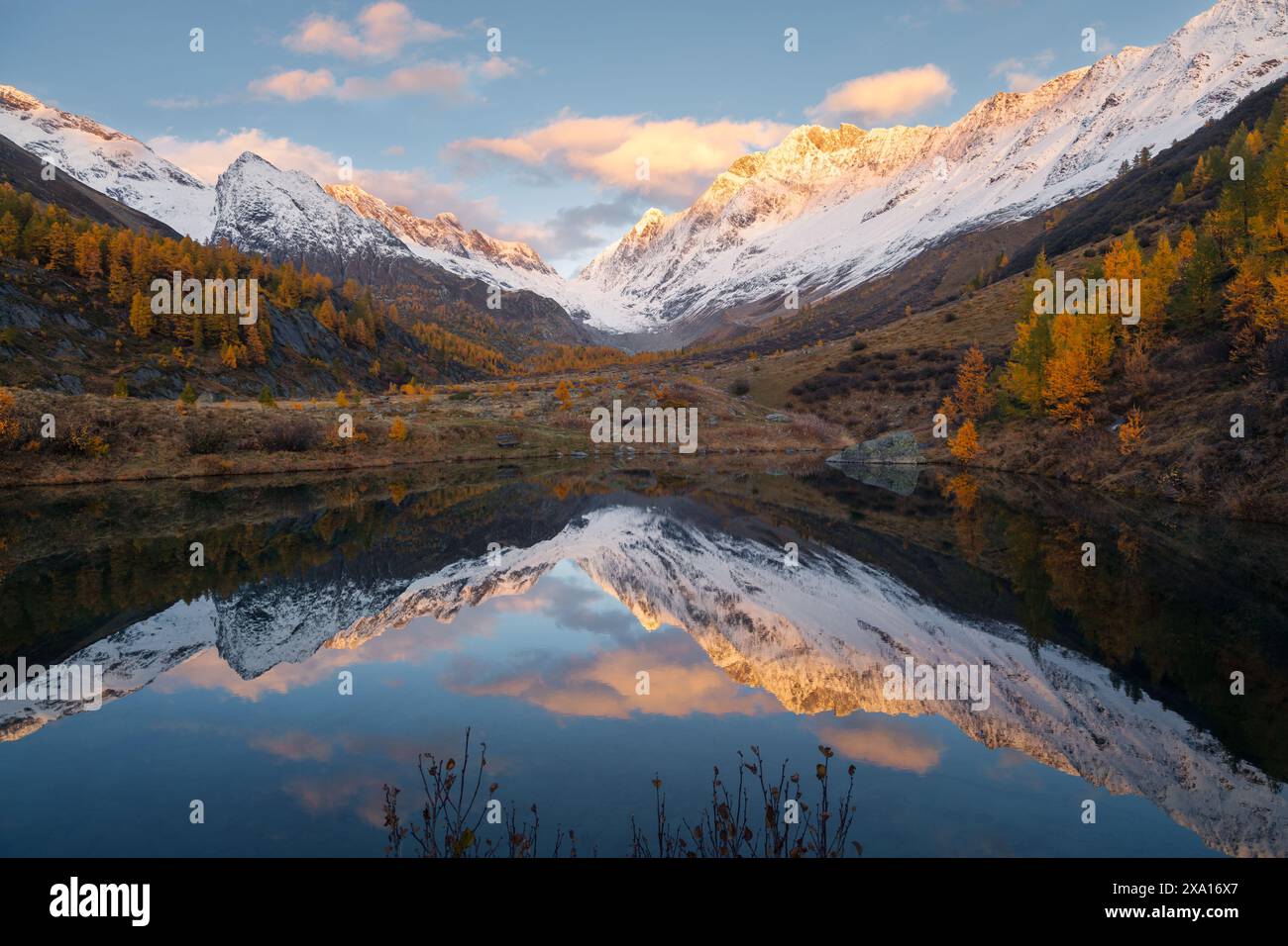 An autumn landscape view of the snow-capped Lotschental mountains ...