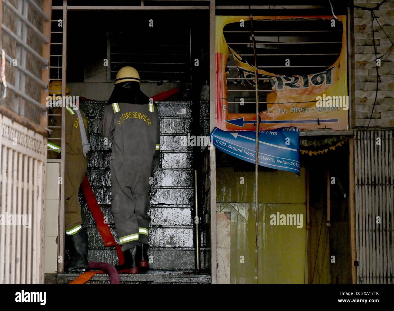 NOIDA, INDIA - JUNE 3: Fire brigade personnel extinguish the fire at a garment factory in Sector ...