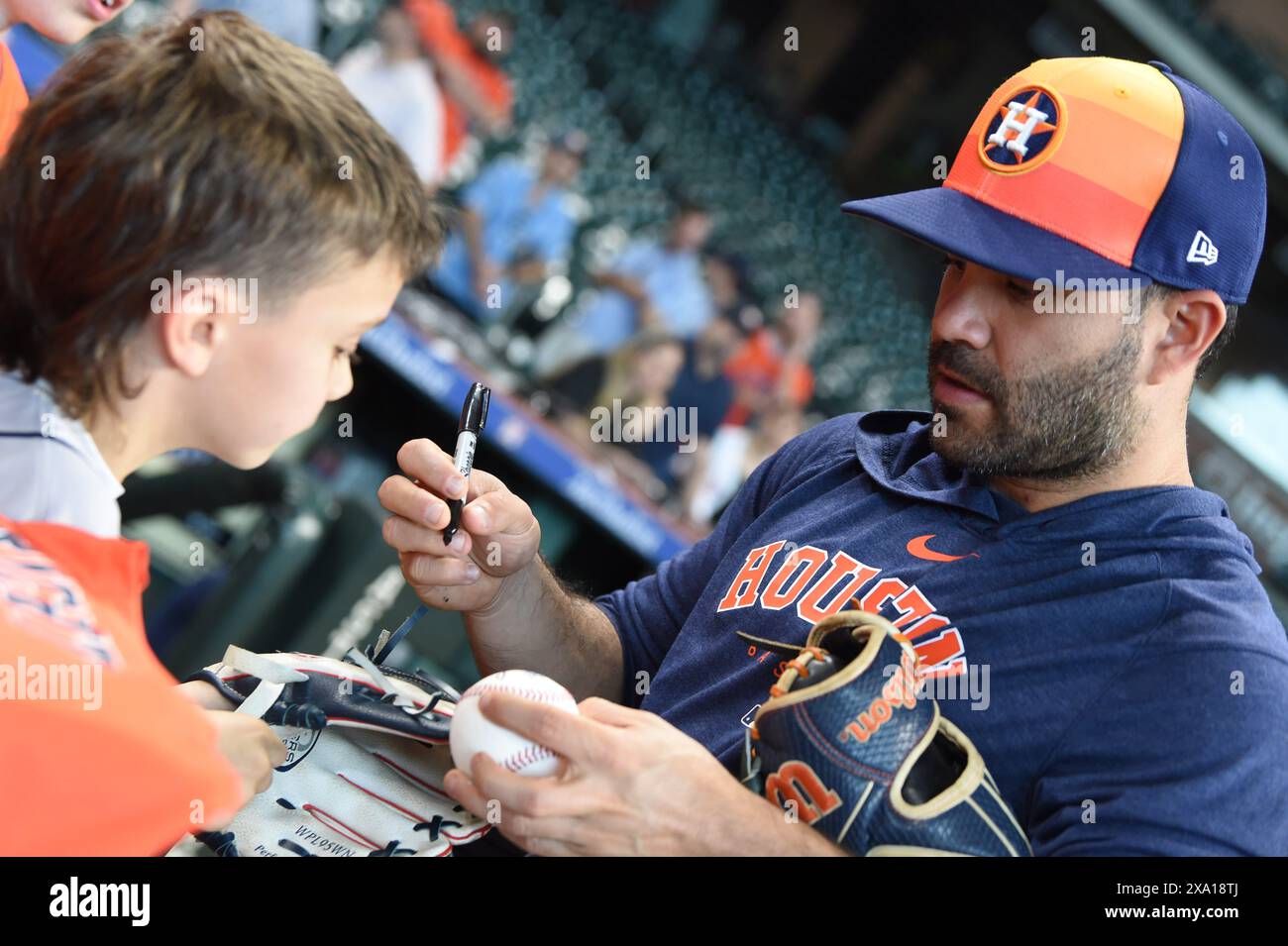 Houston Astros second base Jose Altuve (27) signs an autography for a ...