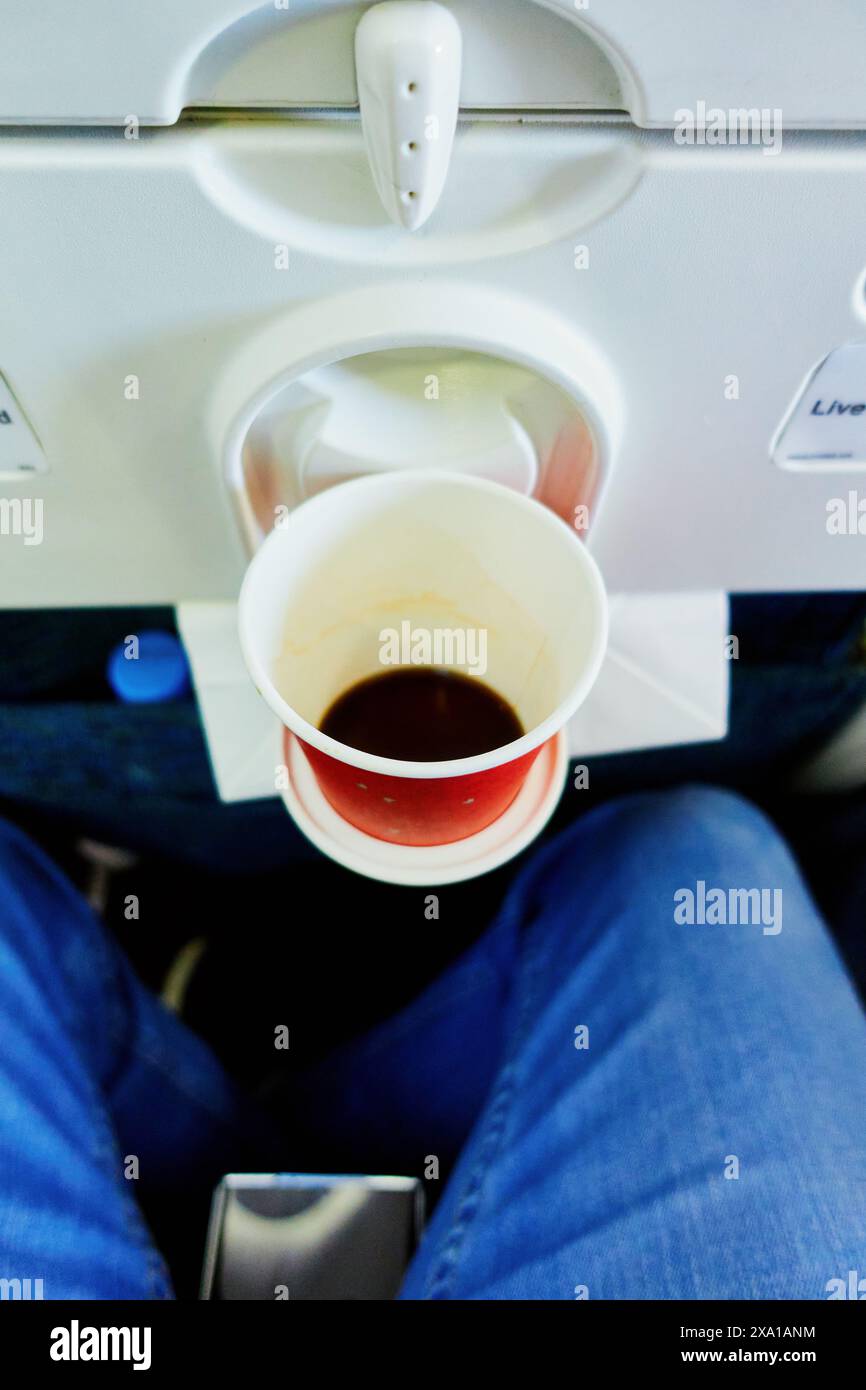 Person drinking coffee on plane hi-res stock photography and images - Alamy