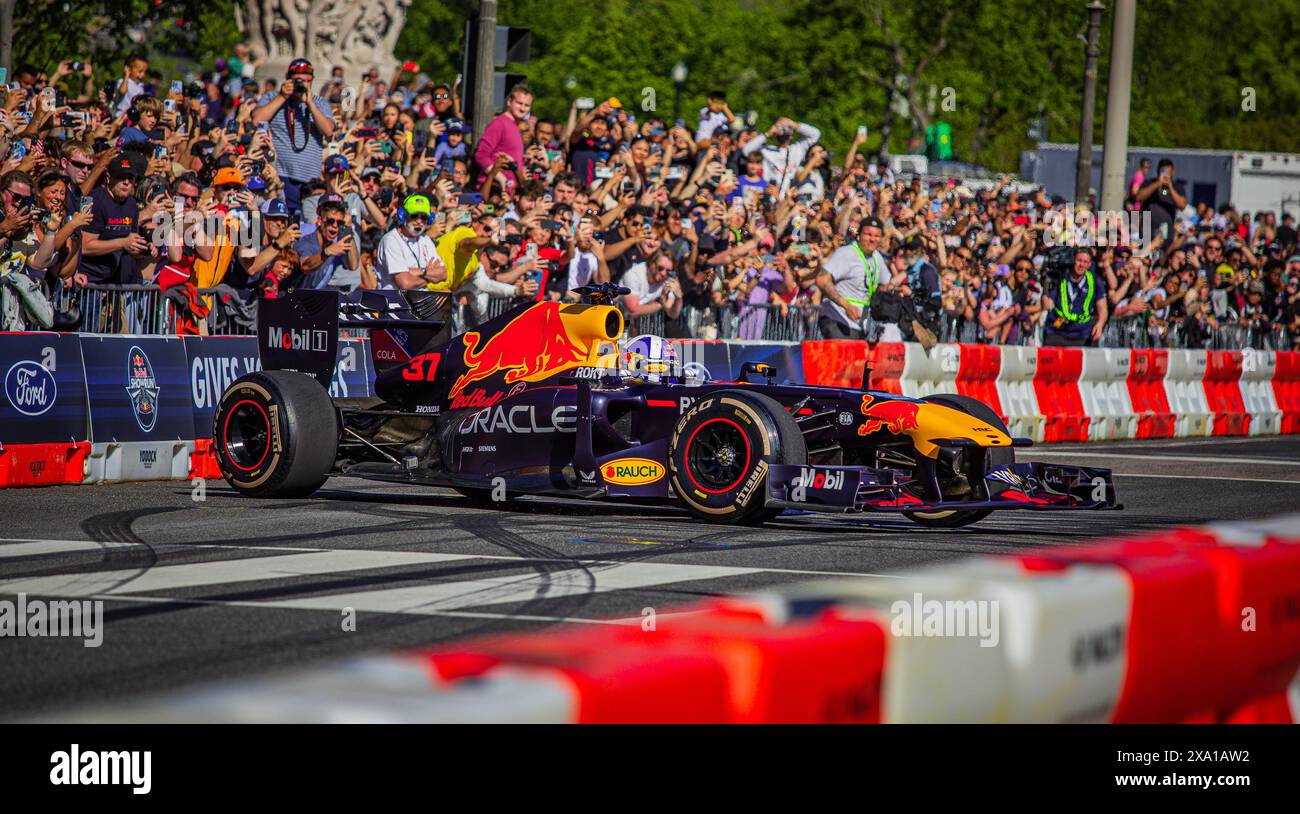 A red racing car captured on camera with audience in background Stock ...