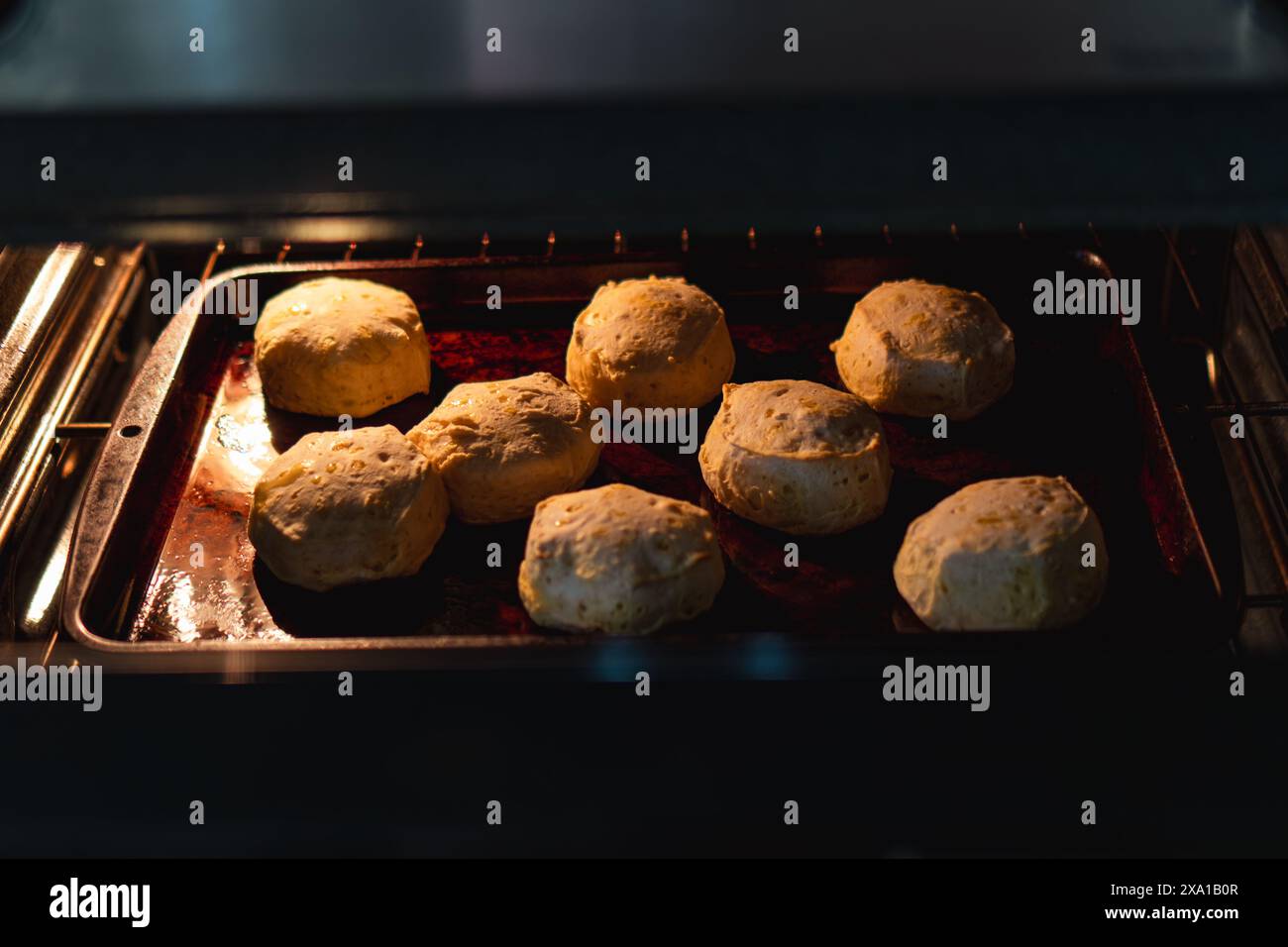 The balls of dough baking in oven at night Stock Photo - Alamy
