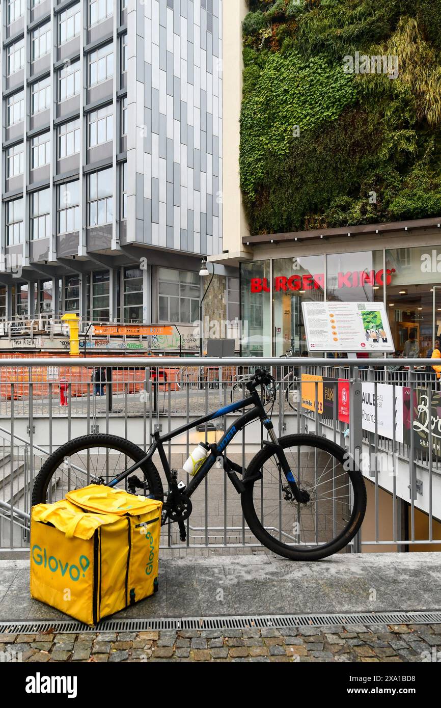 Parked bike of the Glovo home delivery in front of a Burger King fast ...