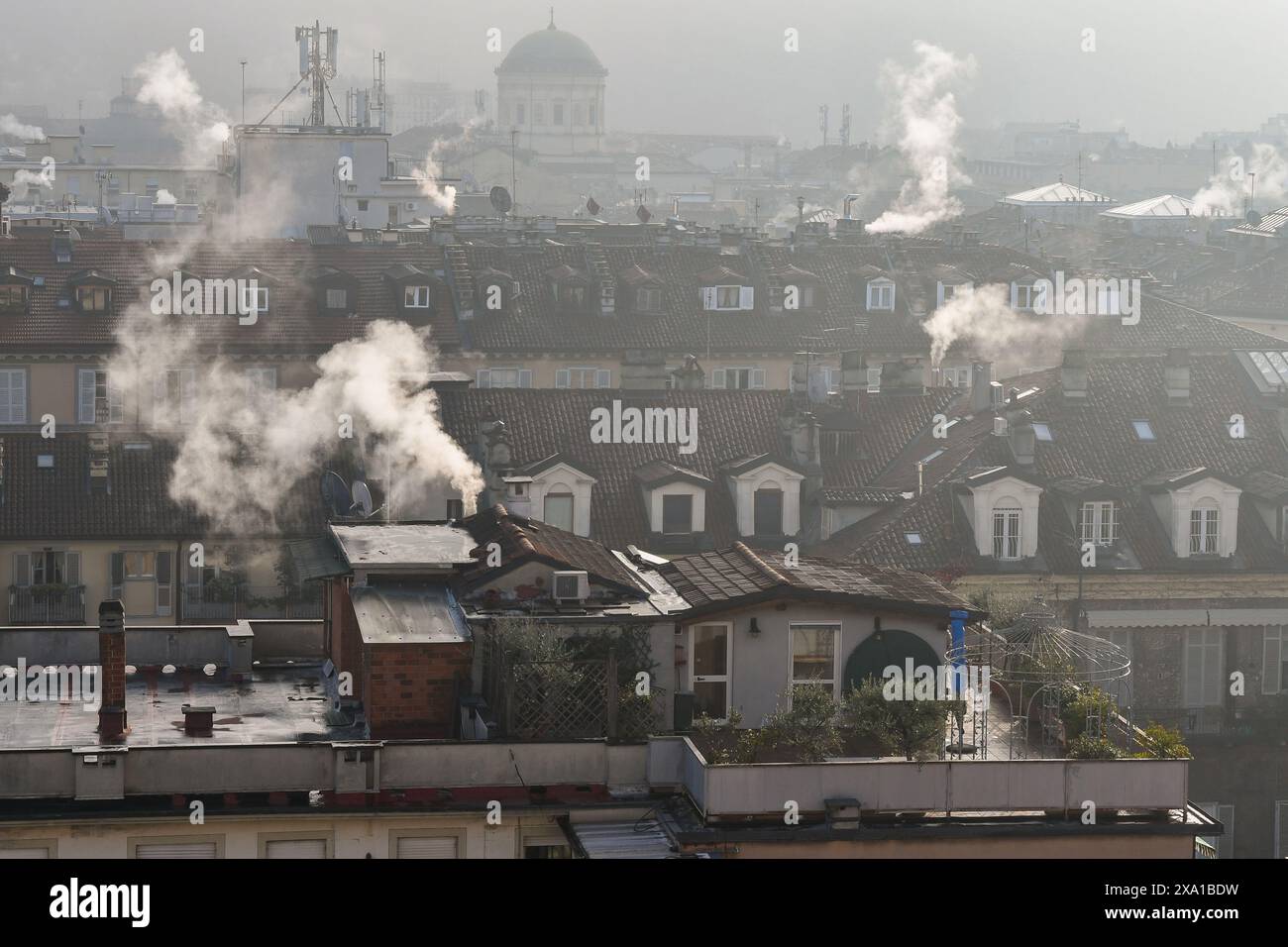 Rooftop view of the historic centre with smoking chimneys on a winter ...