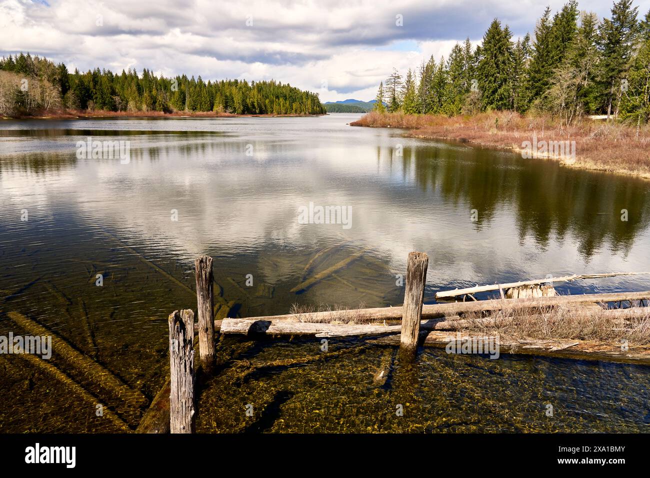 View of a beautiful lake on an overcast day with the pilings remains of ...