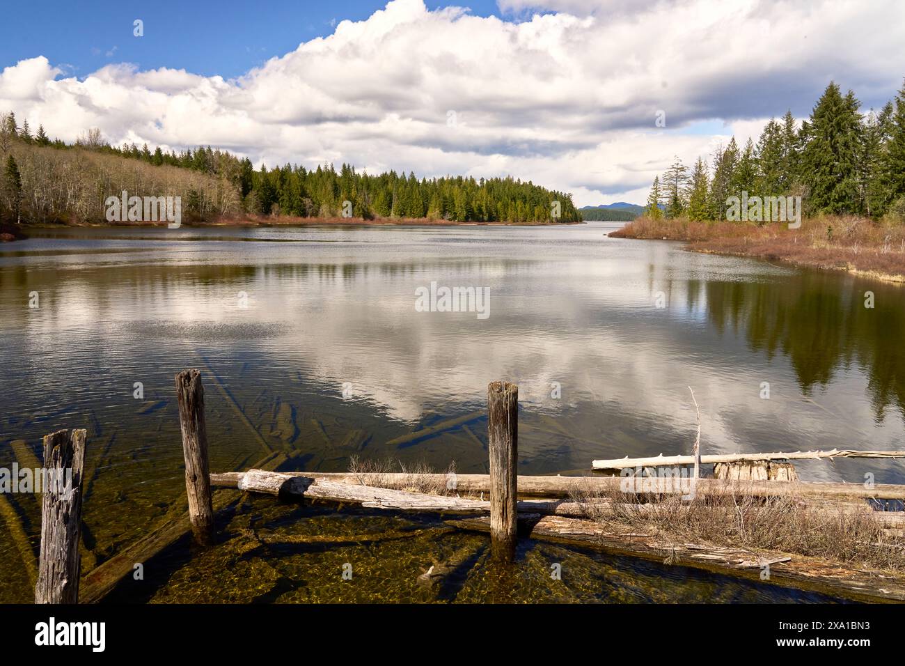 View of a beautiful lake on an overcast day with the pilings remains of ...