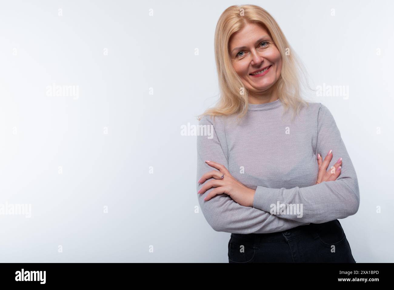 A 45-year-old woman with blond hair and light makeup looks fresh for ...