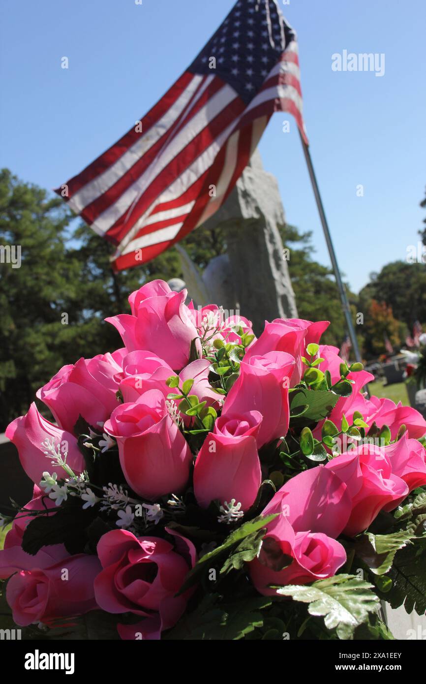 The pink roses and American flag on grave at Rose Hill Cemetery in ...