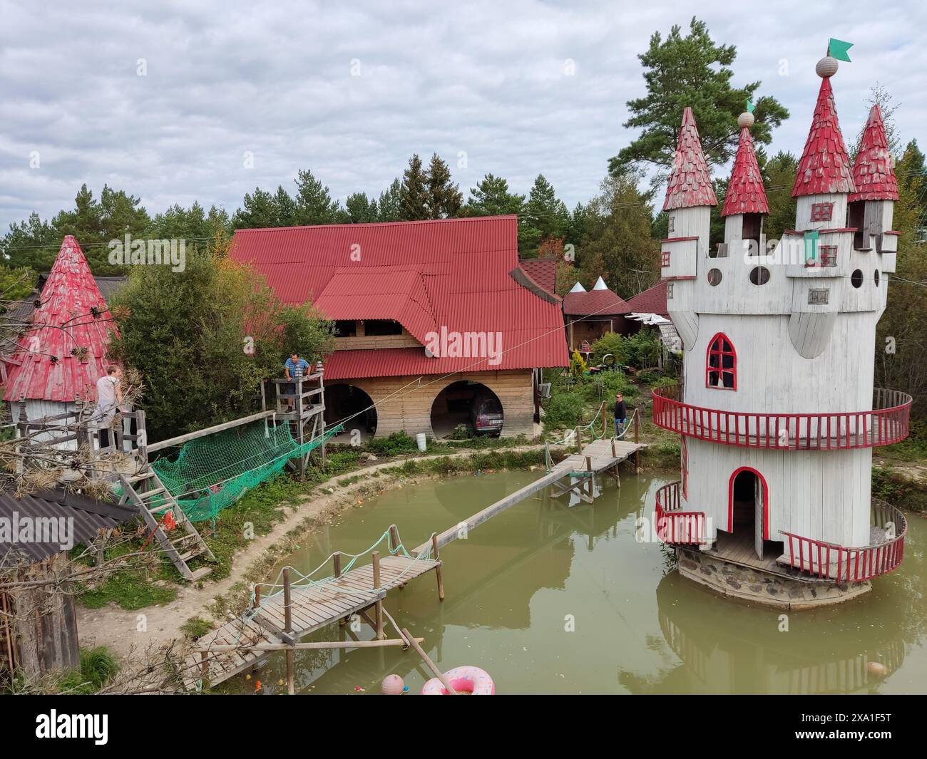 A pink balloon floats in a pool beneath a castle tower Stock Photo - Alamy