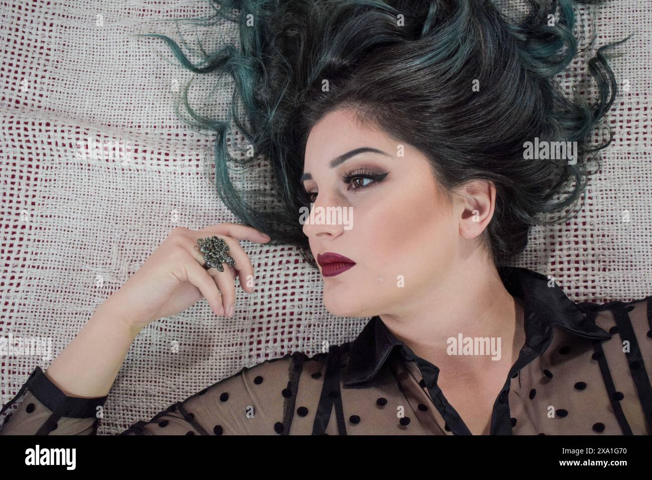 A beautiful goth girl laying in bed thinking while looking away Stock ...