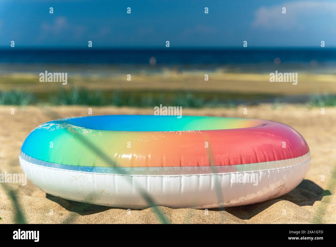 Inflatable donut on a sandy beach Stock Photo - Alamy
