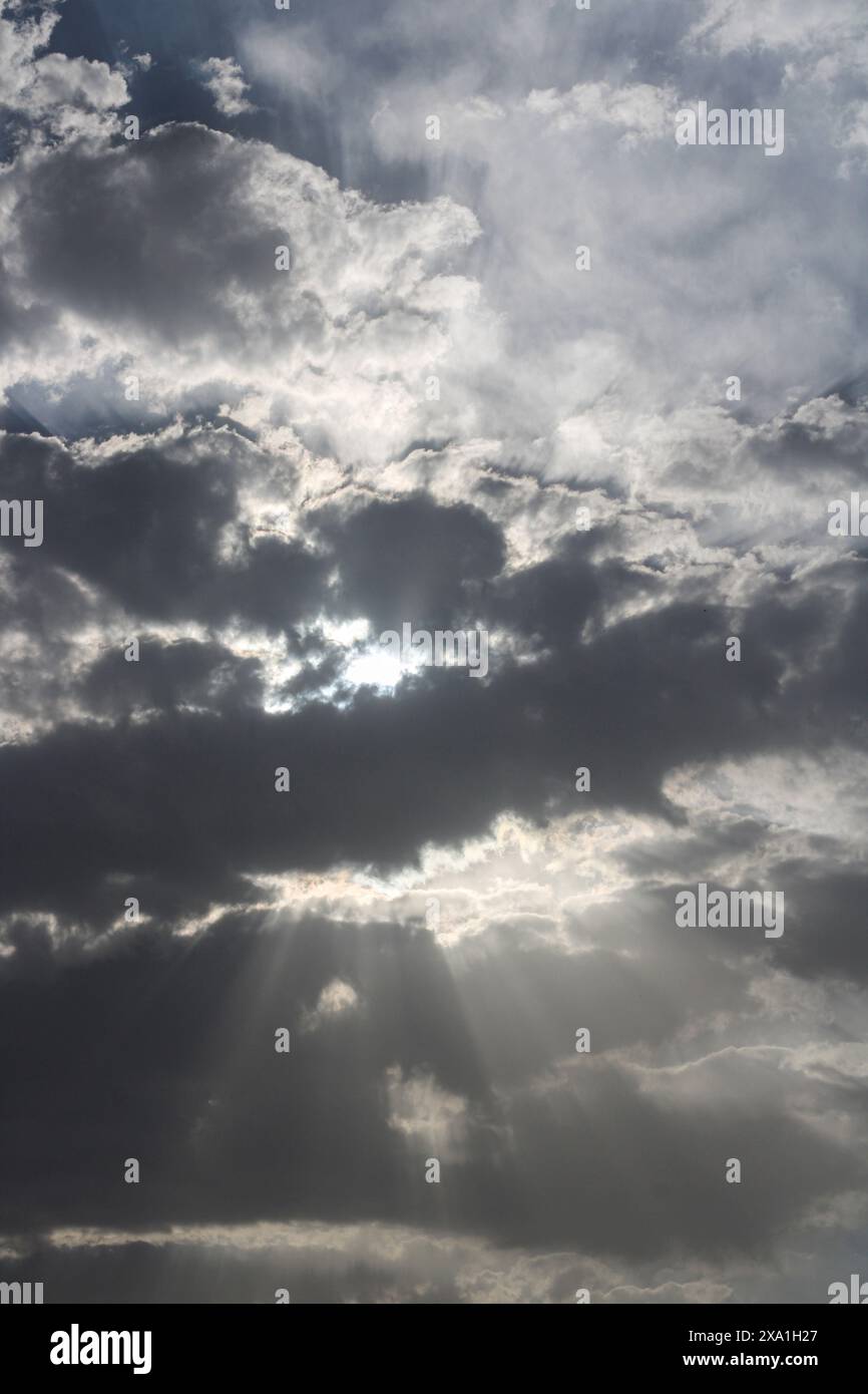 A dramatic dark sky with sun rays breaking through the clouds Stock ...