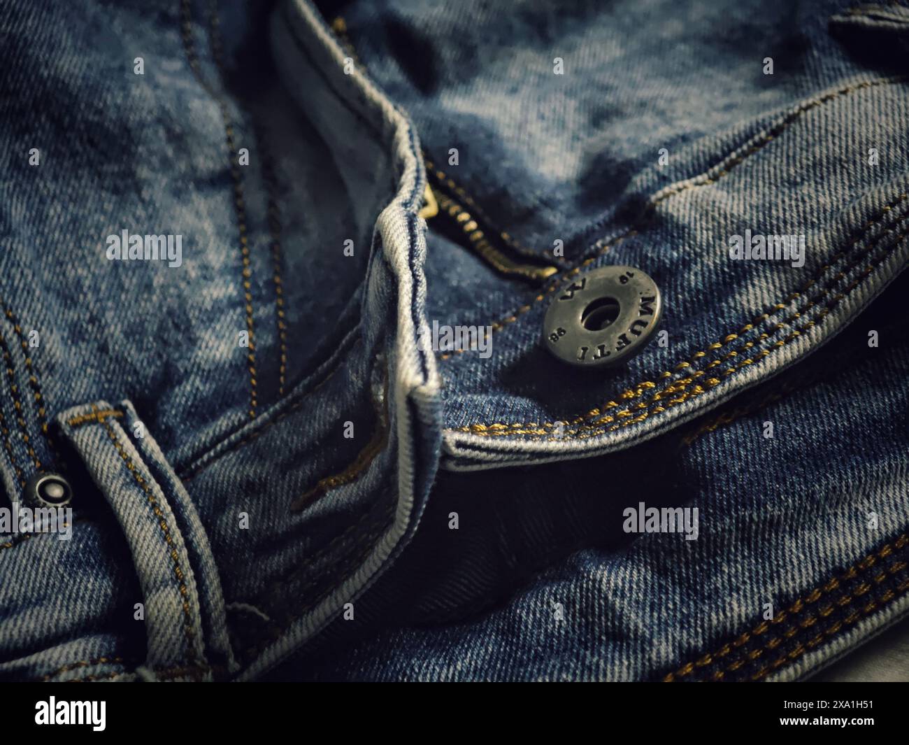 Close-up of a sewn-on button on an unmade denim jacket Stock Photo - Alamy