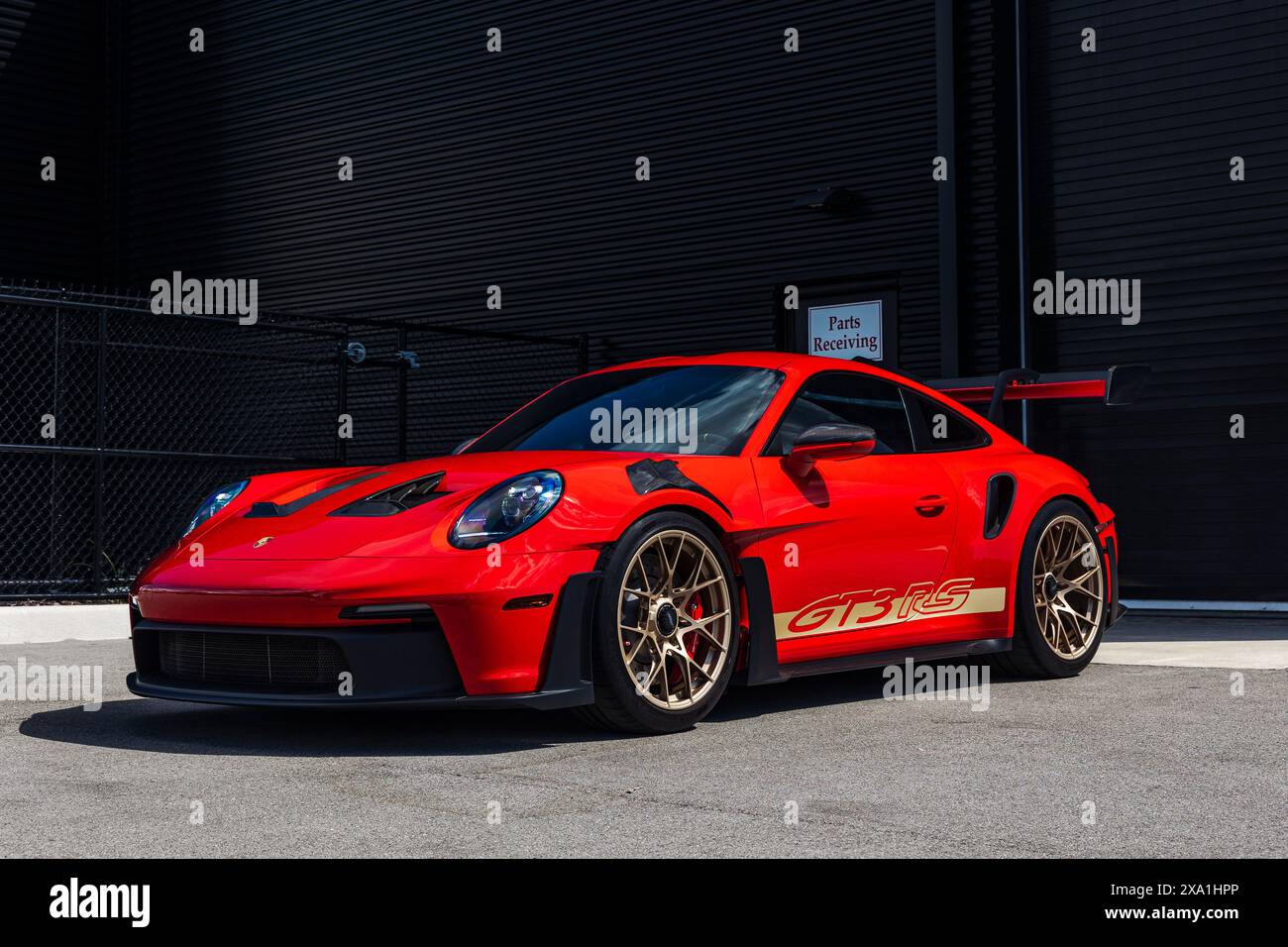 A Guards Red 992 Porsche GT3 RS with Aurum Gold wheels on a road Stock ...
