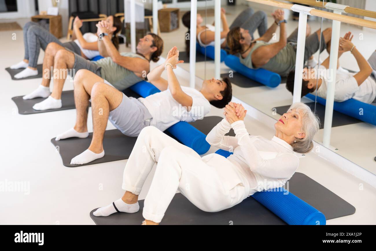 Group of people doing hip bridge exercise in gym Stock Photo - Alamy