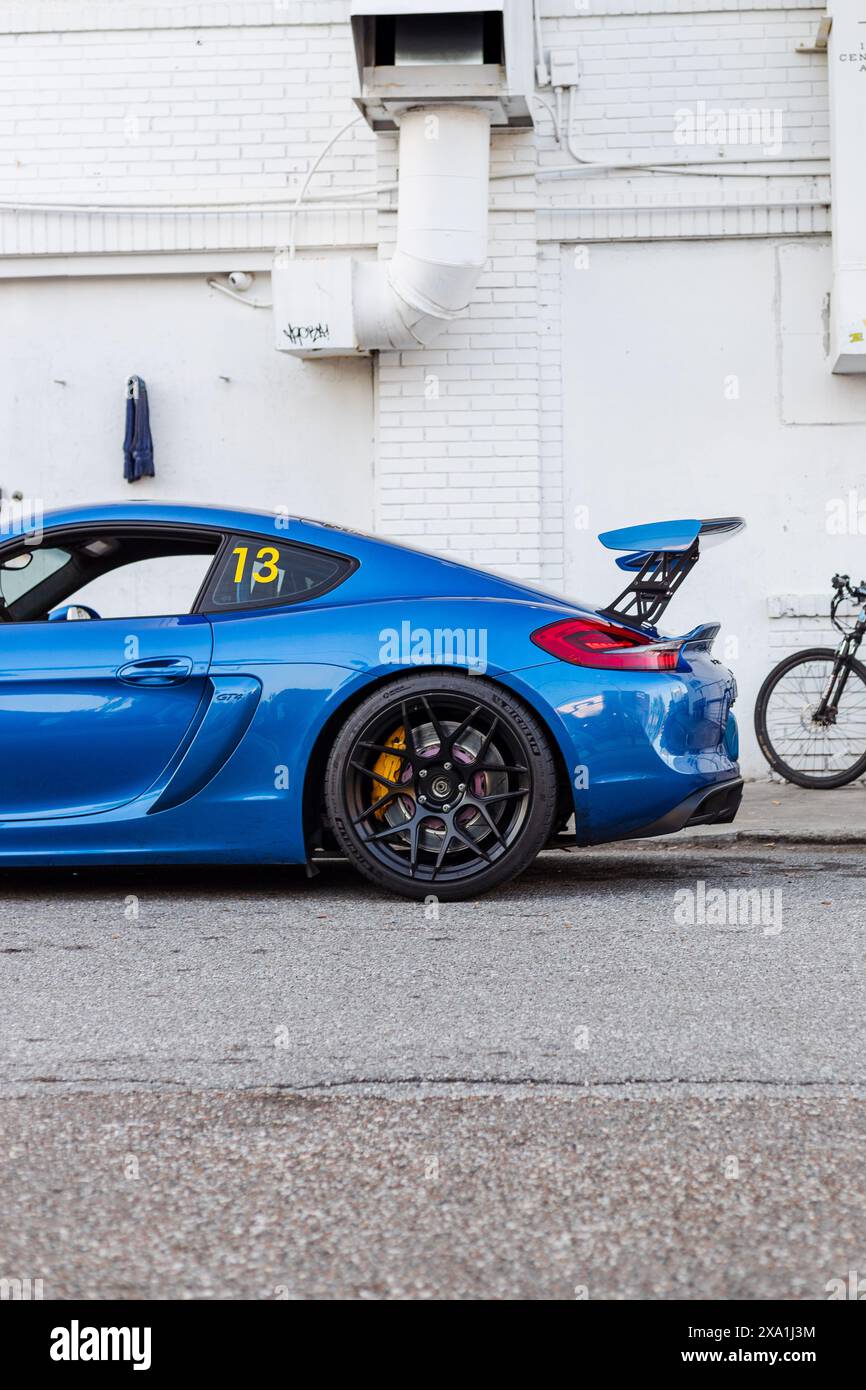 A vertical shot of a beautiful blue Porsche 981 Cayman GT4 race car ...