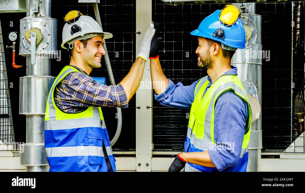 The two construction workers celebrate with a high five on a ...