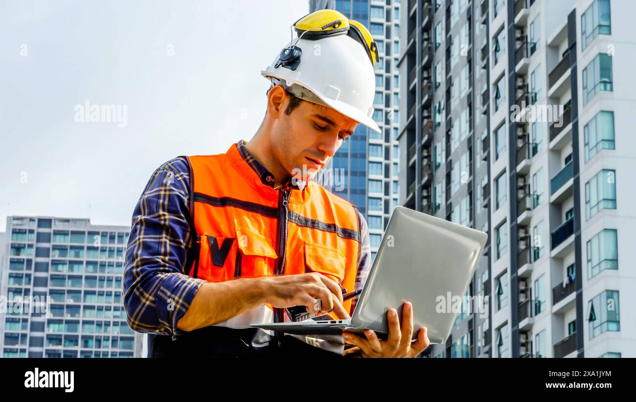An engineer using a laptop in a construction site Stock Photo - Alamy