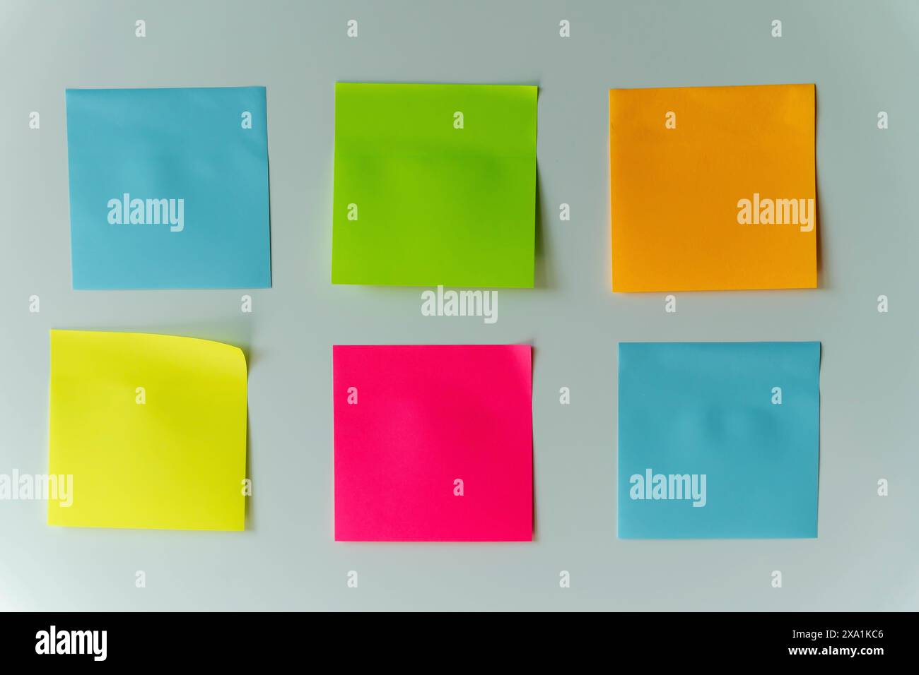 Six colorful sticky notes on a white wall Stock Photo - Alamy