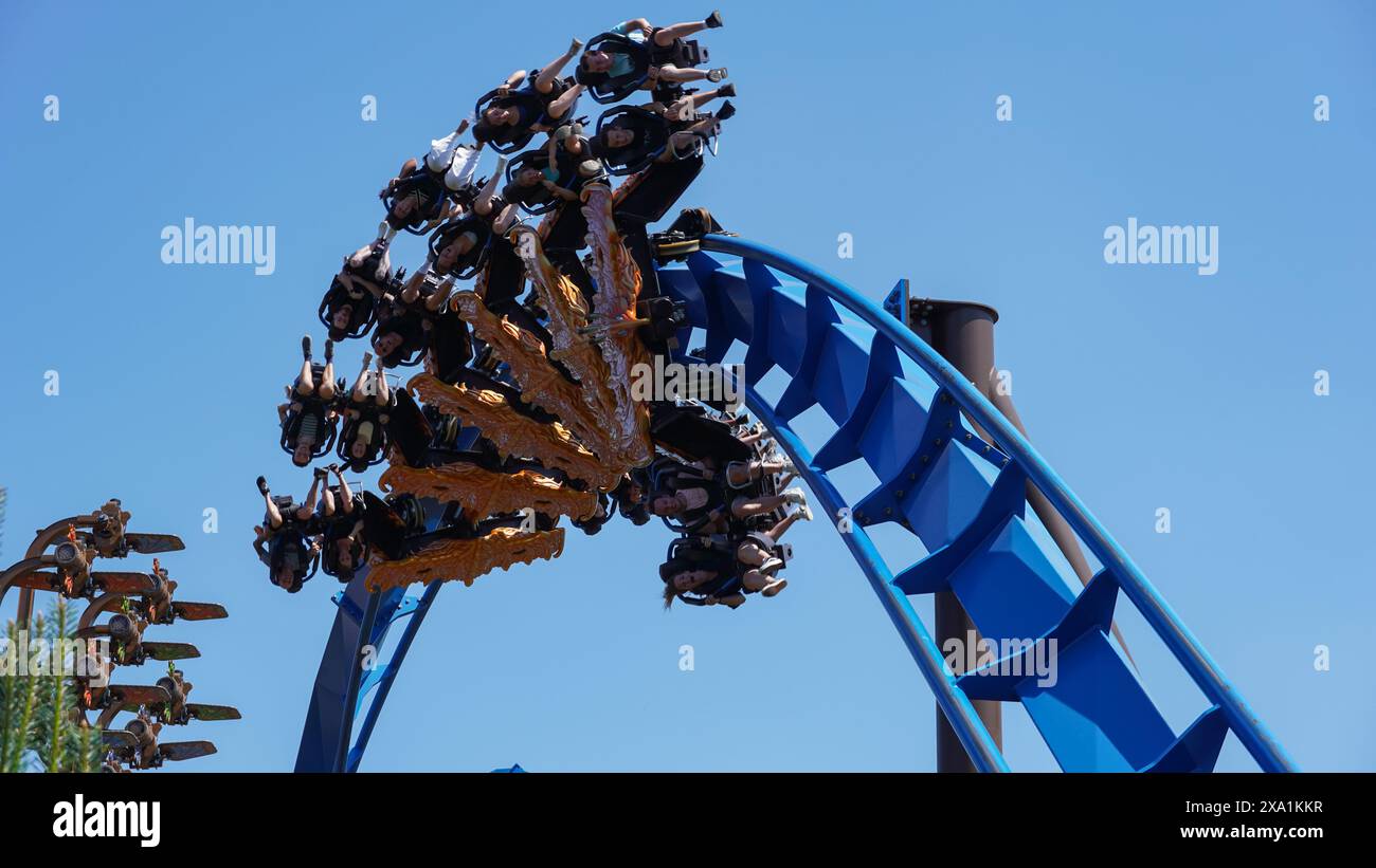 Young people screaming during a ride with the Fenix wing rollercoaster ...