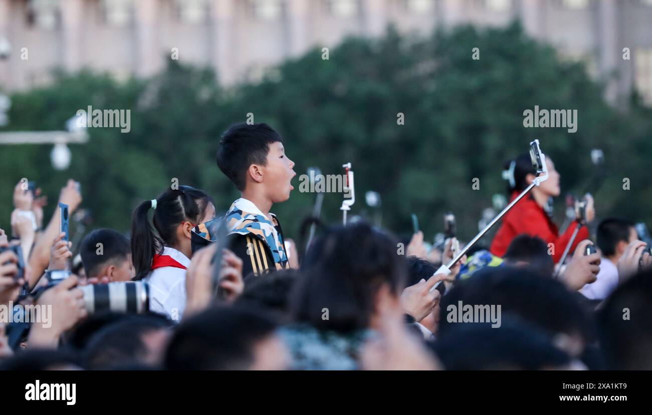BEIJING, CHINA - JUNE 1, 2024 - Tourists attend the national flag ...